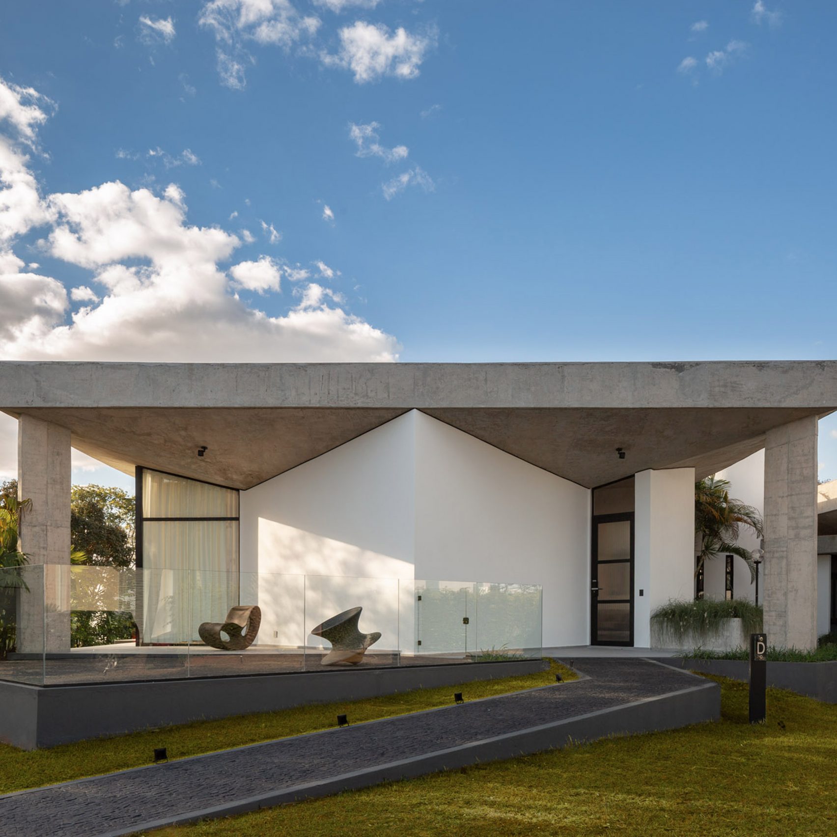 Light wells puncture roof of concrete house in Brasília by Debaixo do ...