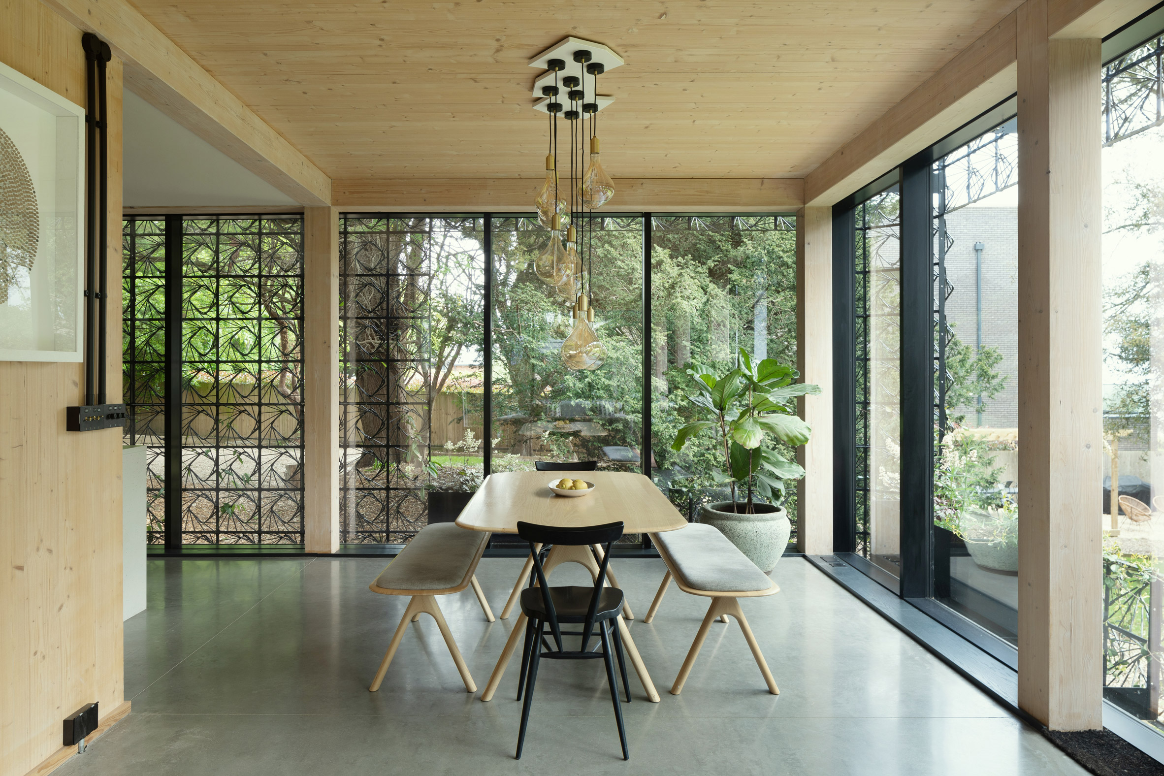 Sculptural steel screen invites nature to grow around Woven House in ...