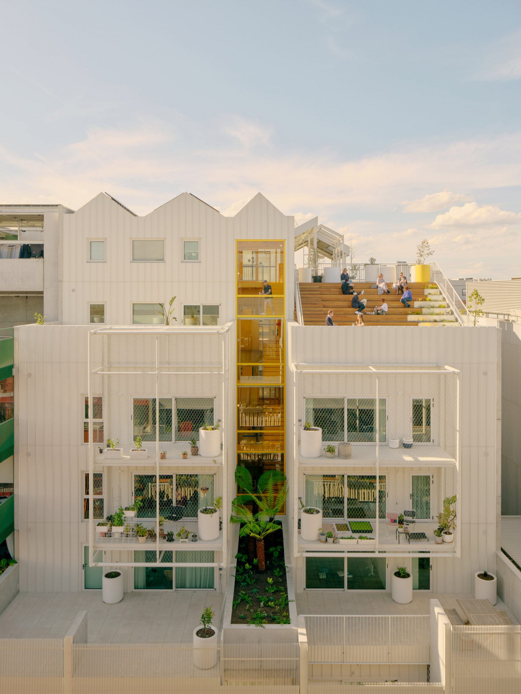 Bright yellow balconies enliven Melbourne apartment block by Austin ...