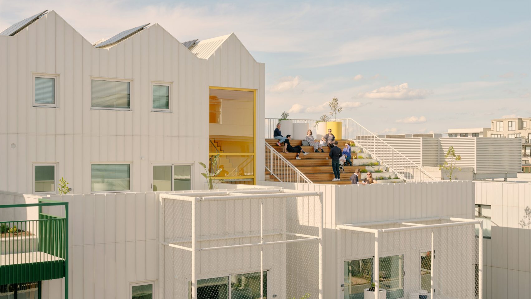 Bright yellow balconies enliven Melbourne apartment block by Austin ...