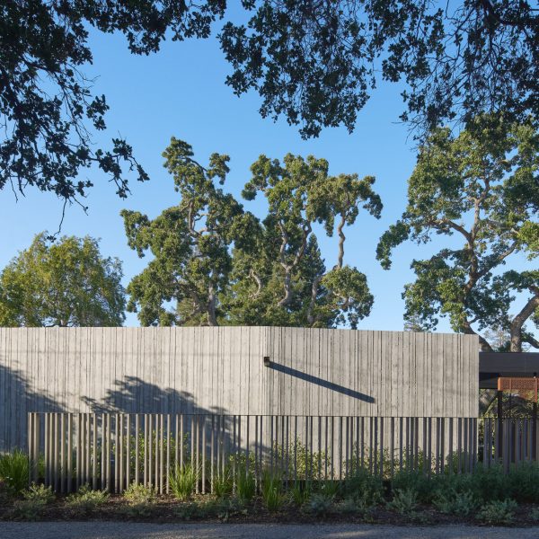Tall "acoustic wall" buffers noise at Modal Home in Silicon Valley