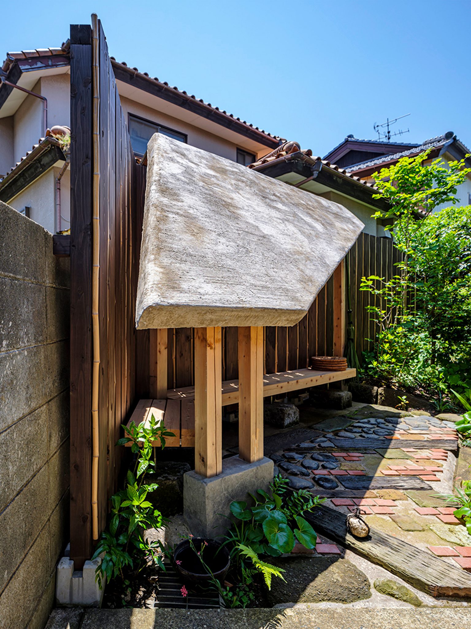Sloping earthen roof tops waiting area for Japanese tea room by ...